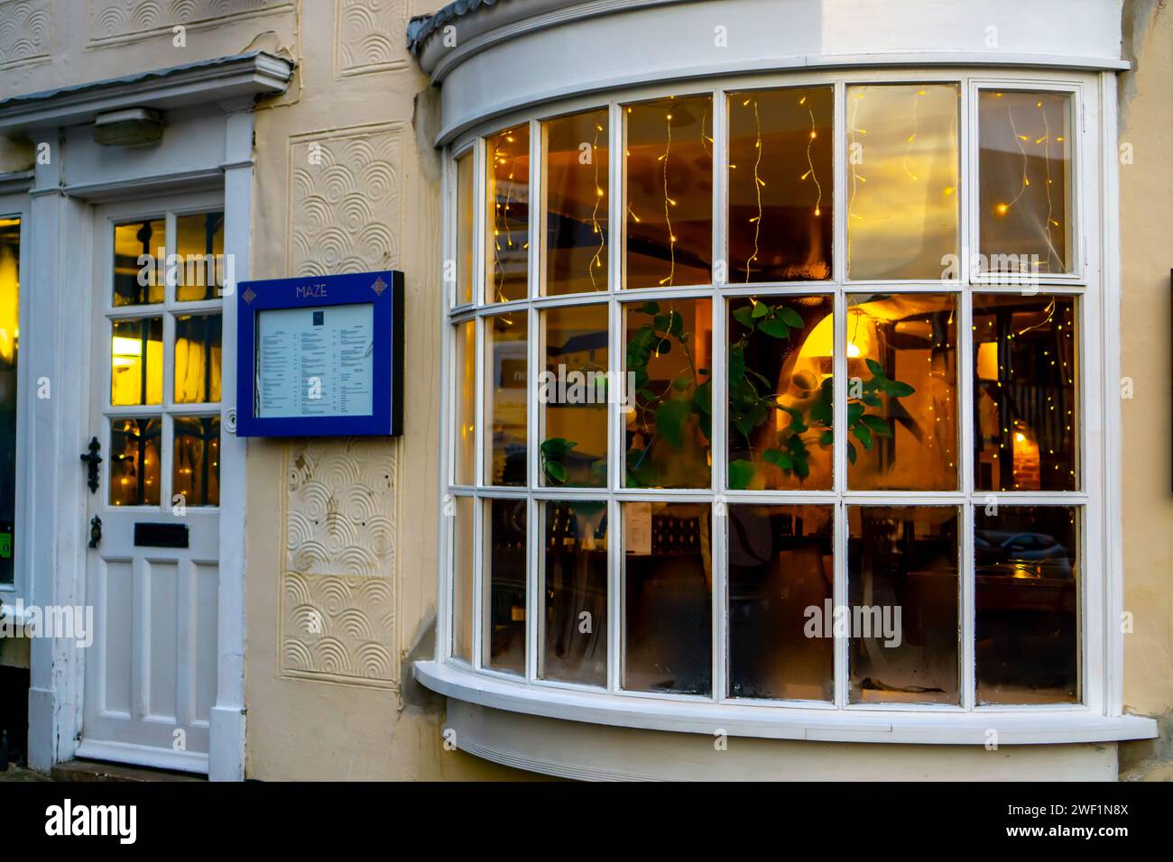 Lit up bay window of the Maze restaurant in the market place Saffron ...