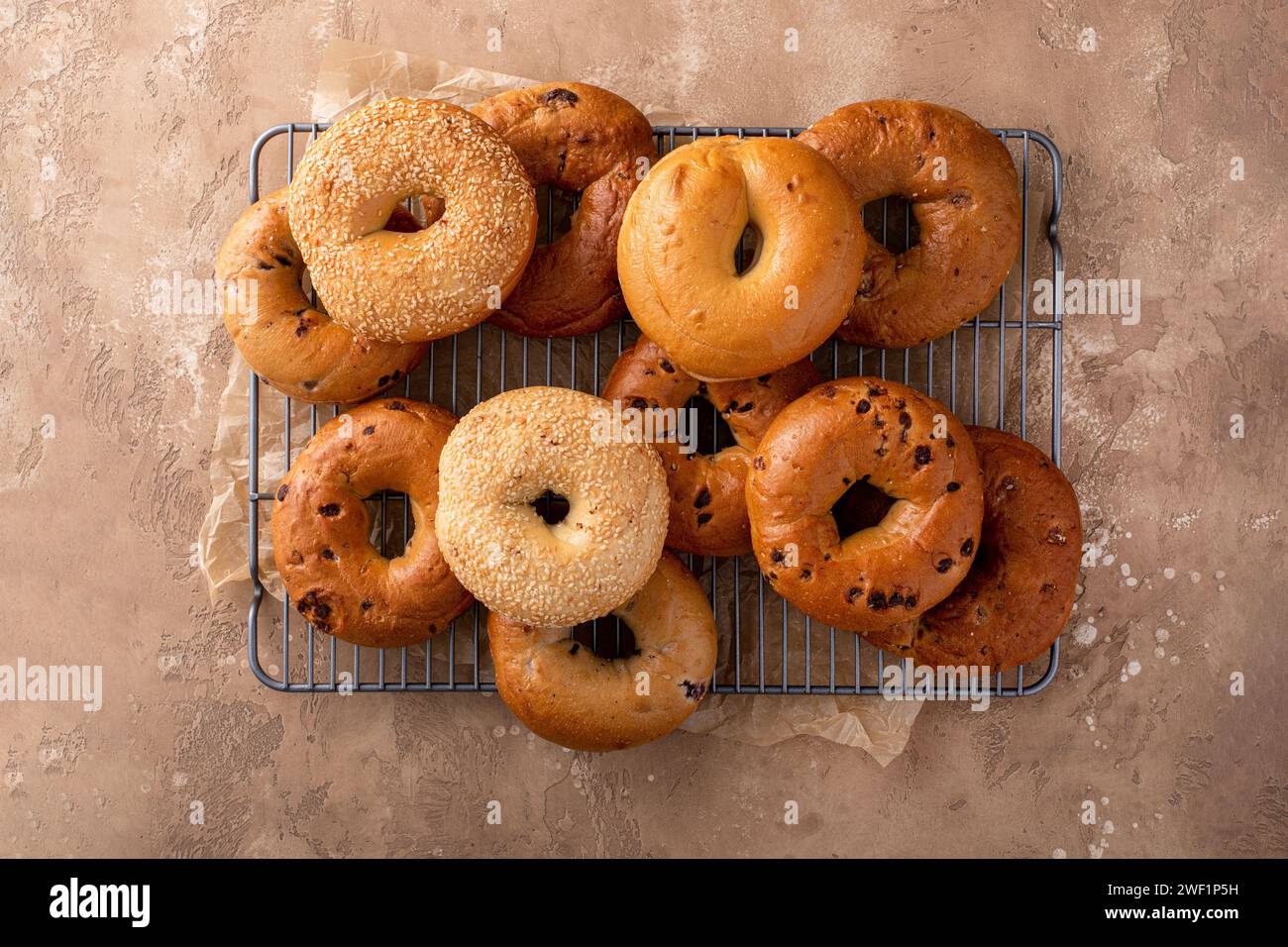 Variety of bagels freshly baked for breakfast with plain, sesame and cinnamon raisin overhead ...