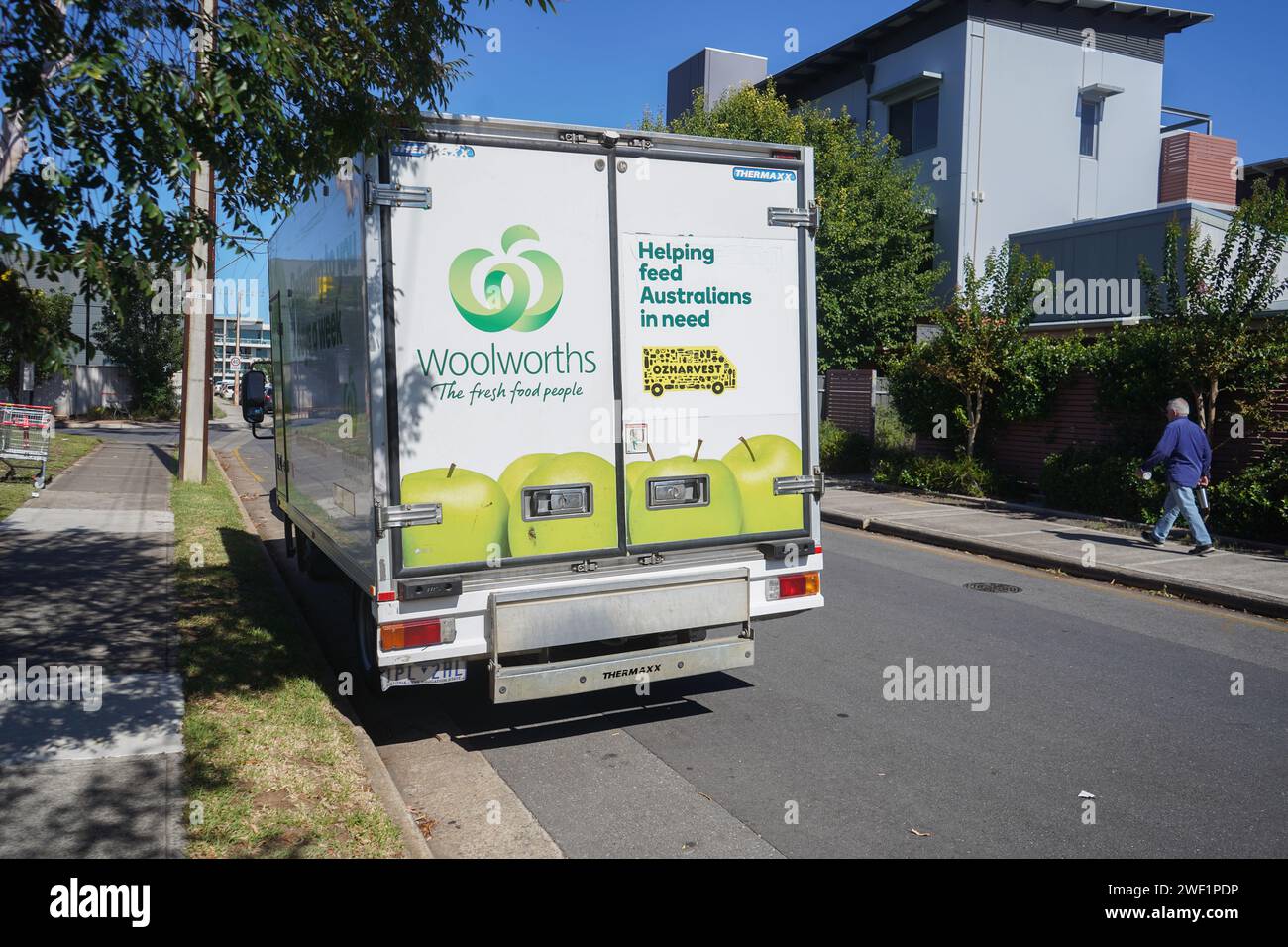 A Woolworths grocery delivery truck parked in a suburban street in ...
