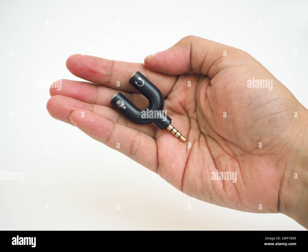 hand holding splitter audio jack two line for microphone and headset ...