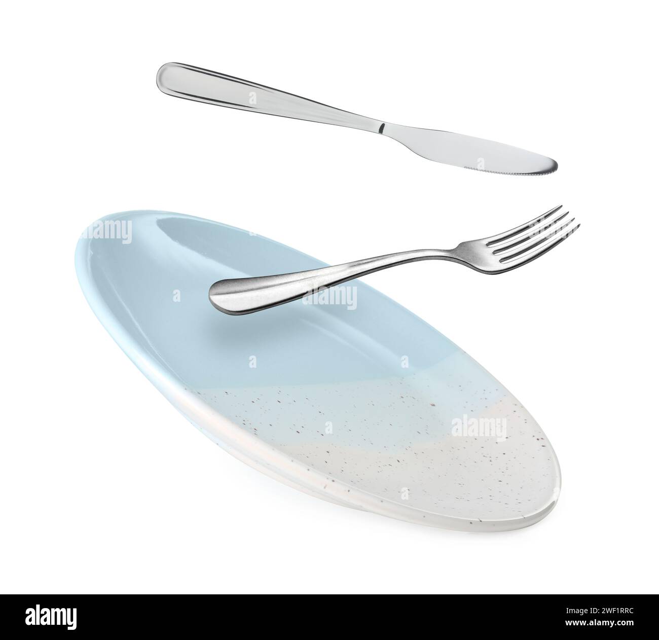 Clean plate, fork and knife falling on white background Stock Photo - Alamy