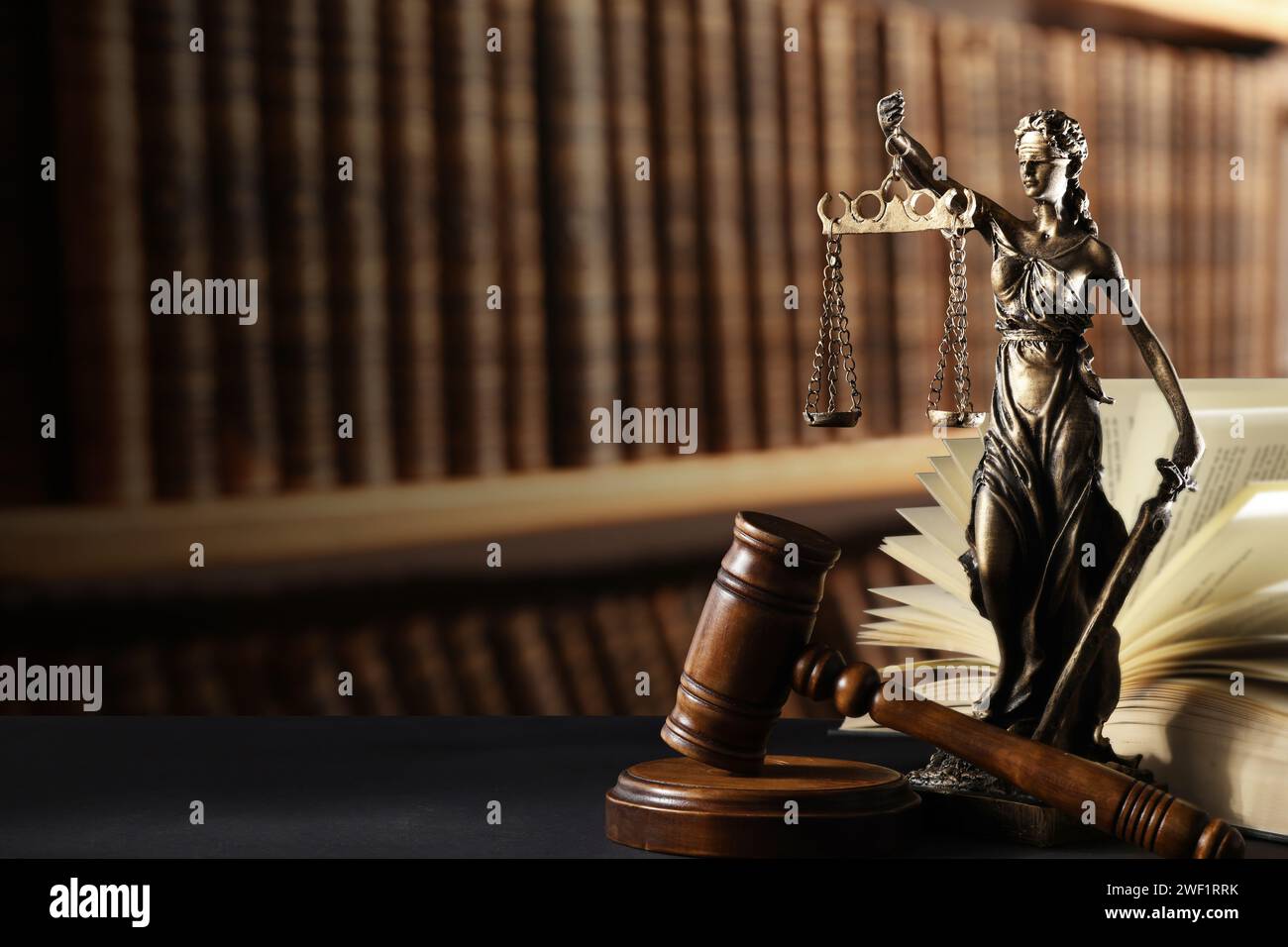 Law. Statue of Lady Justice, gavel and open book on black table indoors ...