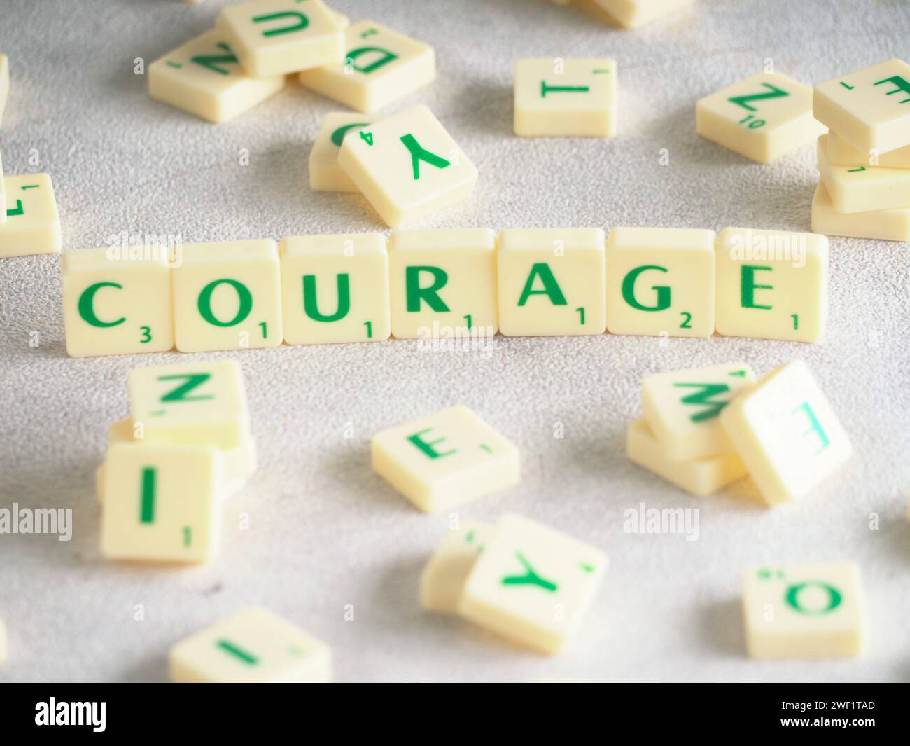 Scrabble letters spelling words Courage Stock Photo - Alamy