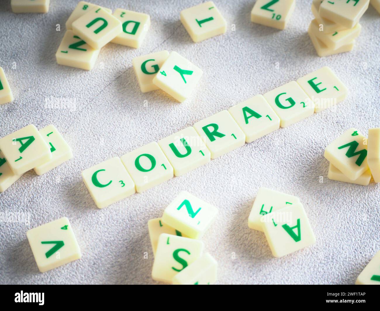 Scrabble letters spelling words Courage Stock Photo - Alamy