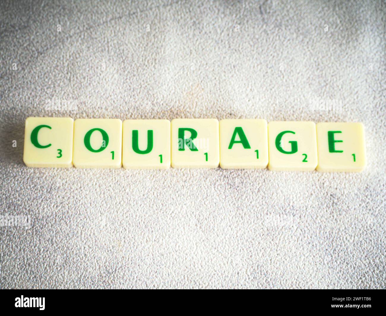 Scrabble letters spelling words Courage Stock Photo - Alamy