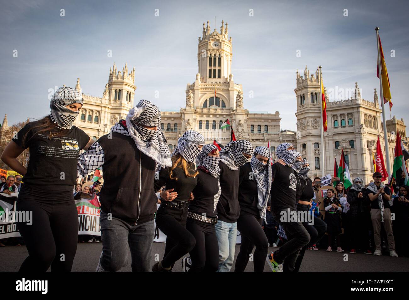 Masked protesters perform Arab dances during the demonstration. Pro ...