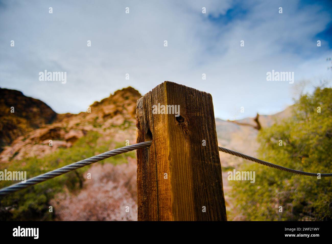 Close up image of a typical weather beaten worn fence post hold up ...