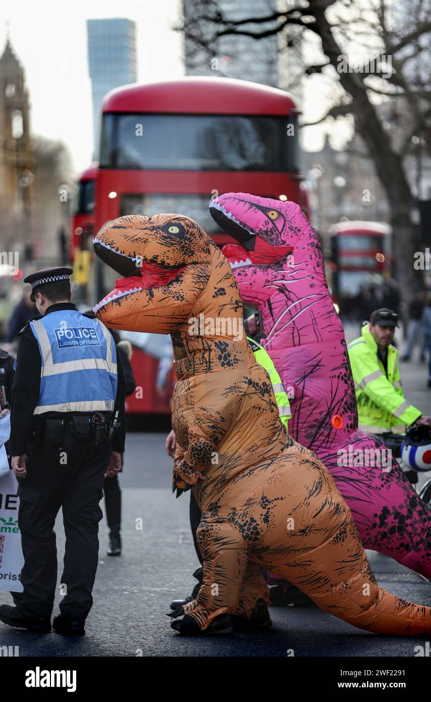 London, UK. 27th Jan, 2024. Police officers try to clear the street as ...
