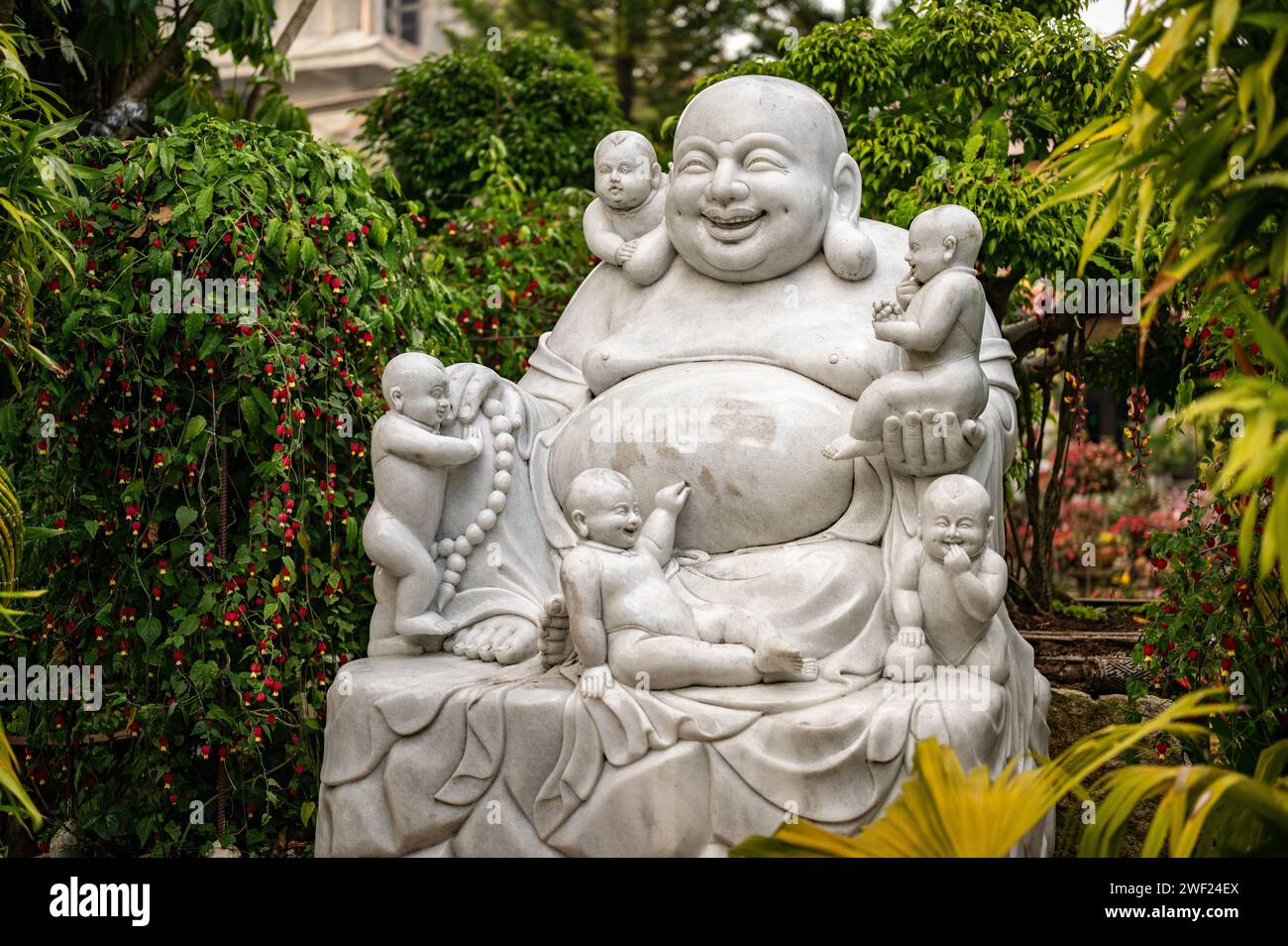 magnificent white marble sculpture of Hotei sitting in traditional ...