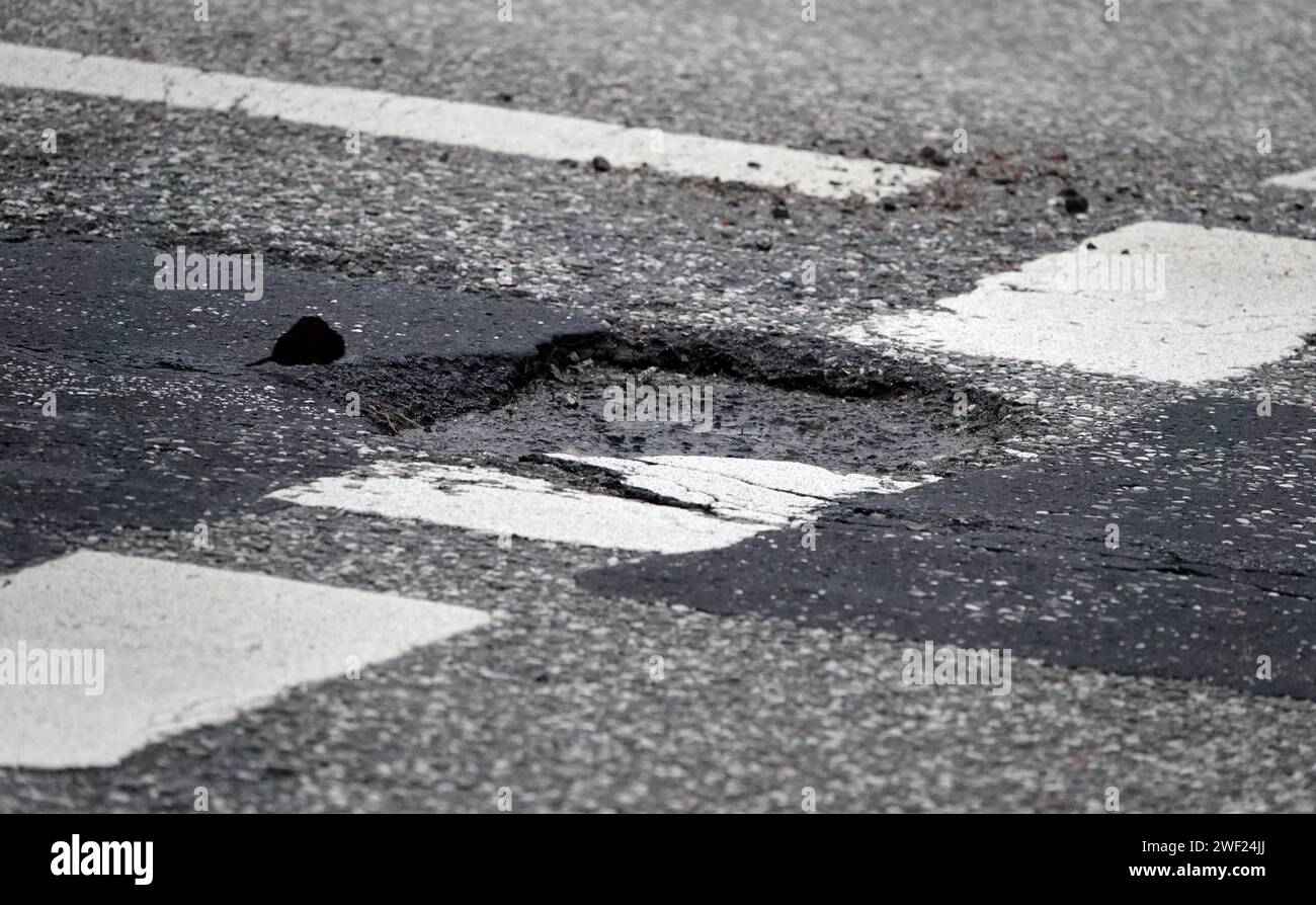 Hamburg, Germany. 24th Jan, 2024. A pothole can be seen on ...
