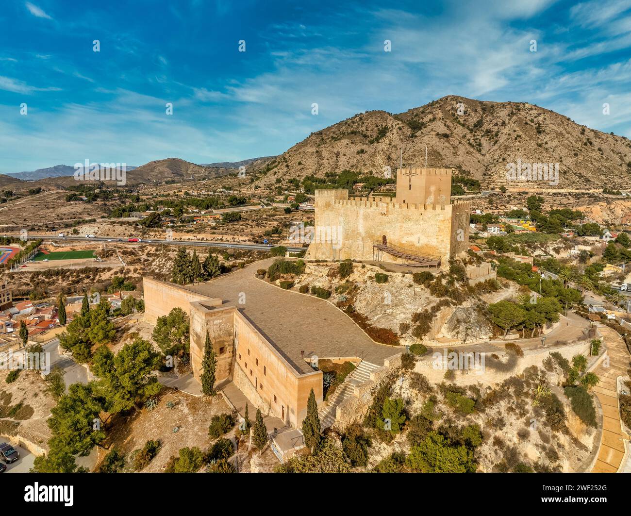 Aerial view of Petrer, medieval town and hilltop castle with restored ...
