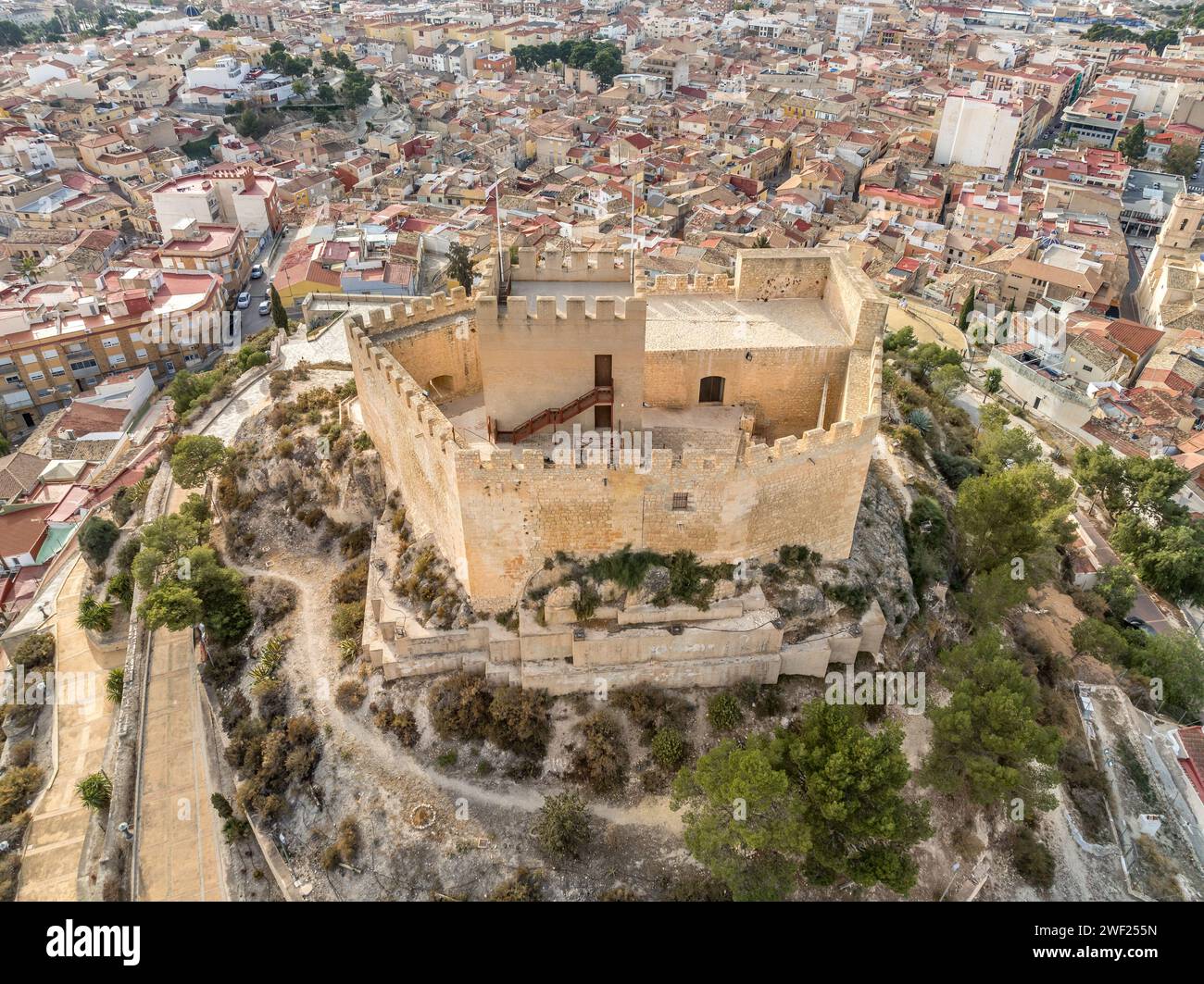 Aerial view of Petrer, medieval town and hilltop castle with restored ...