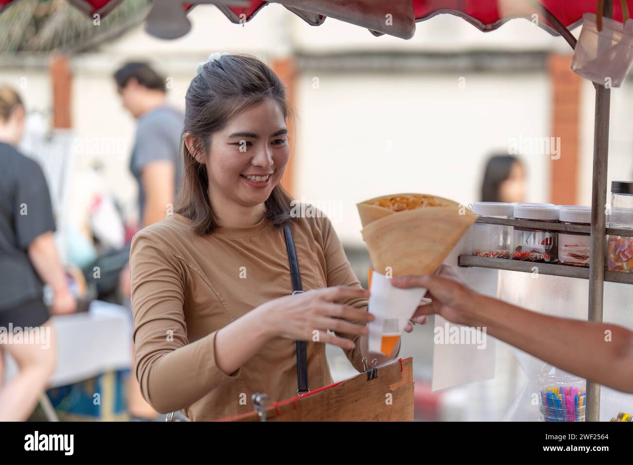 Happy young Asian Traveler foodie woman order Crepes at outdoor night ...