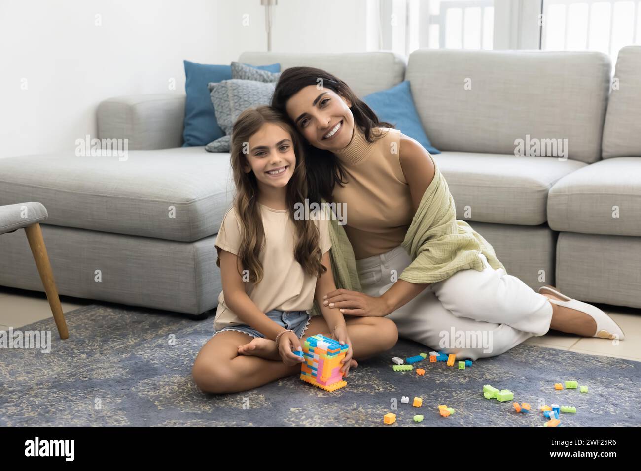 Cheerful cute kid girl and Latin mom posing for portrait Stock Photo ...