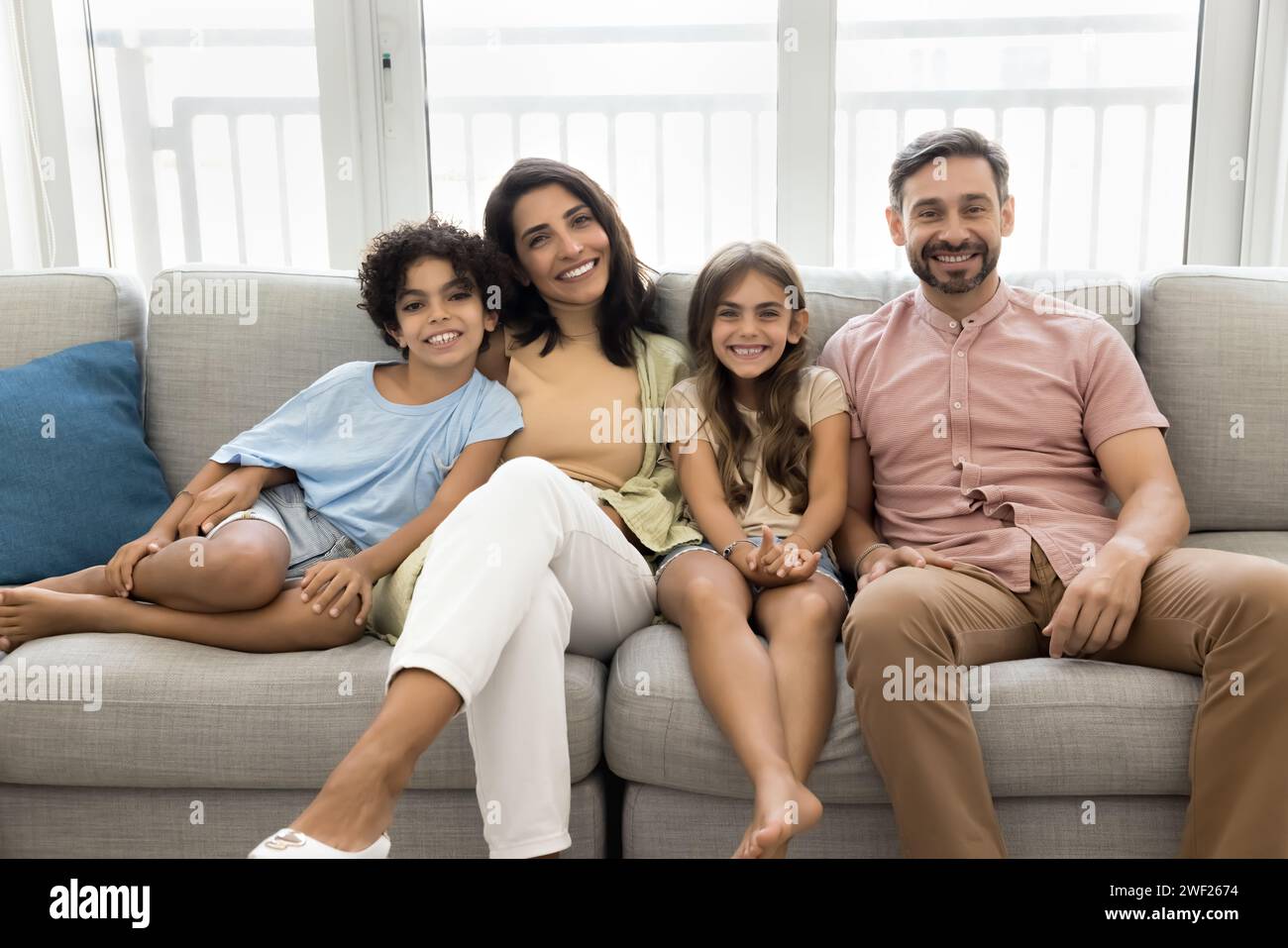 Happy family couple and cheerful sibling kids home portrait Stock Photo ...