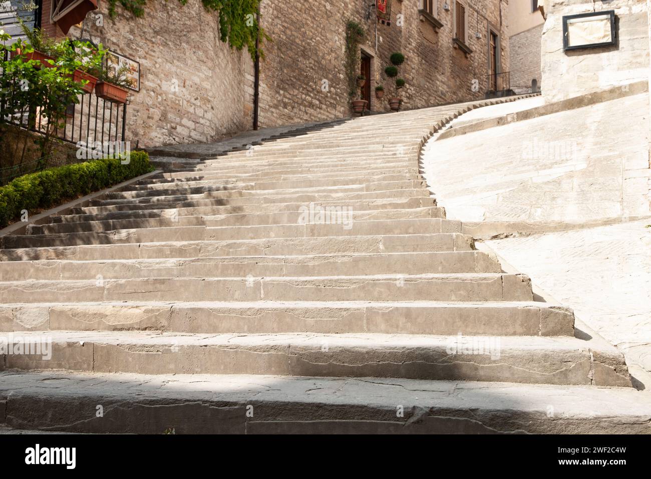 Wide concrete steps leading upward to arched entrance and turning left ...