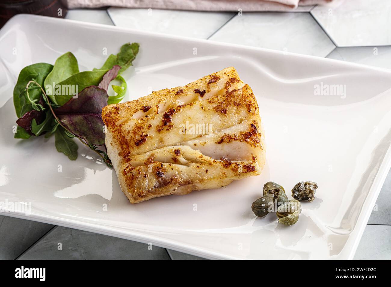 Roasted cod fish steak with salad leaves Stock Photo - Alamy