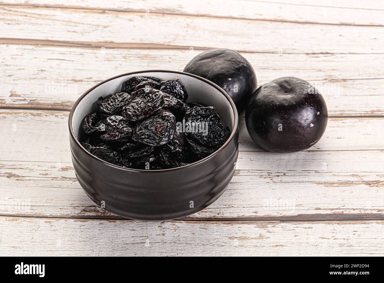Dry sweet prunes in thw bowl Stock Photo - Alamy
