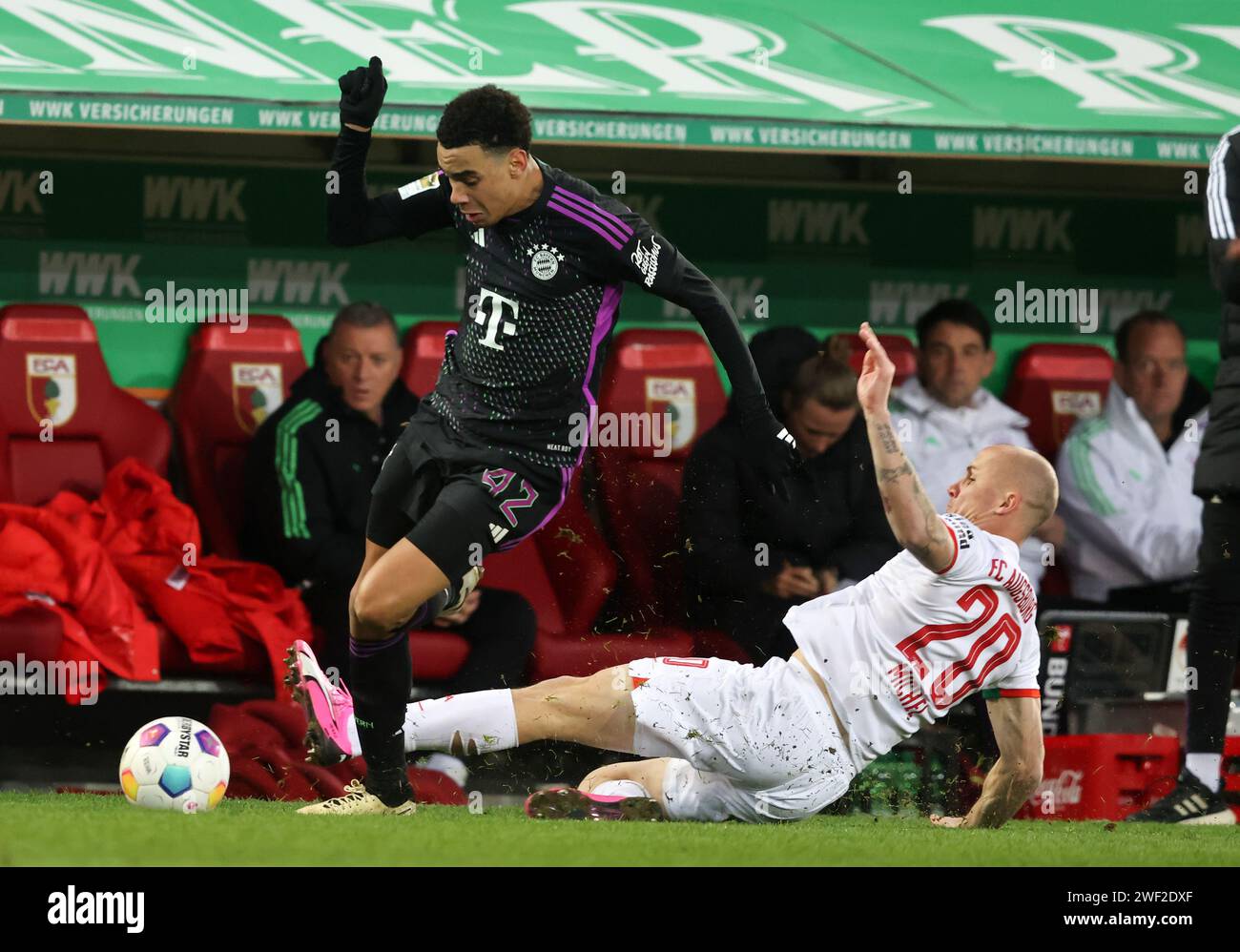 Jamal Musiala of Bayern Muenchen Sven Michel of FC Augsburg FC Augsburg ...