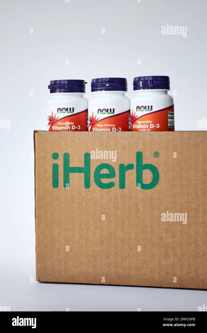 iHerb online store, Unpacking the parcel with vitamins and Nutritional Supplements. Three jars ...