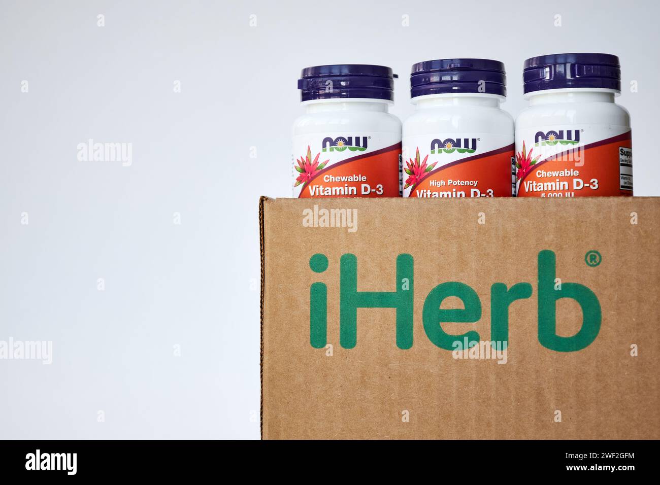 iHerb online store, Unpacking the parcel with vitamins and Nutritional Supplements. Three jars ...