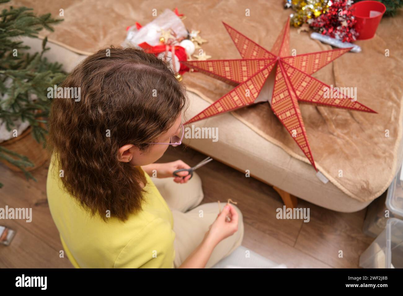 Cleaning up Christmas tree decorations in the home room after Christmas ...