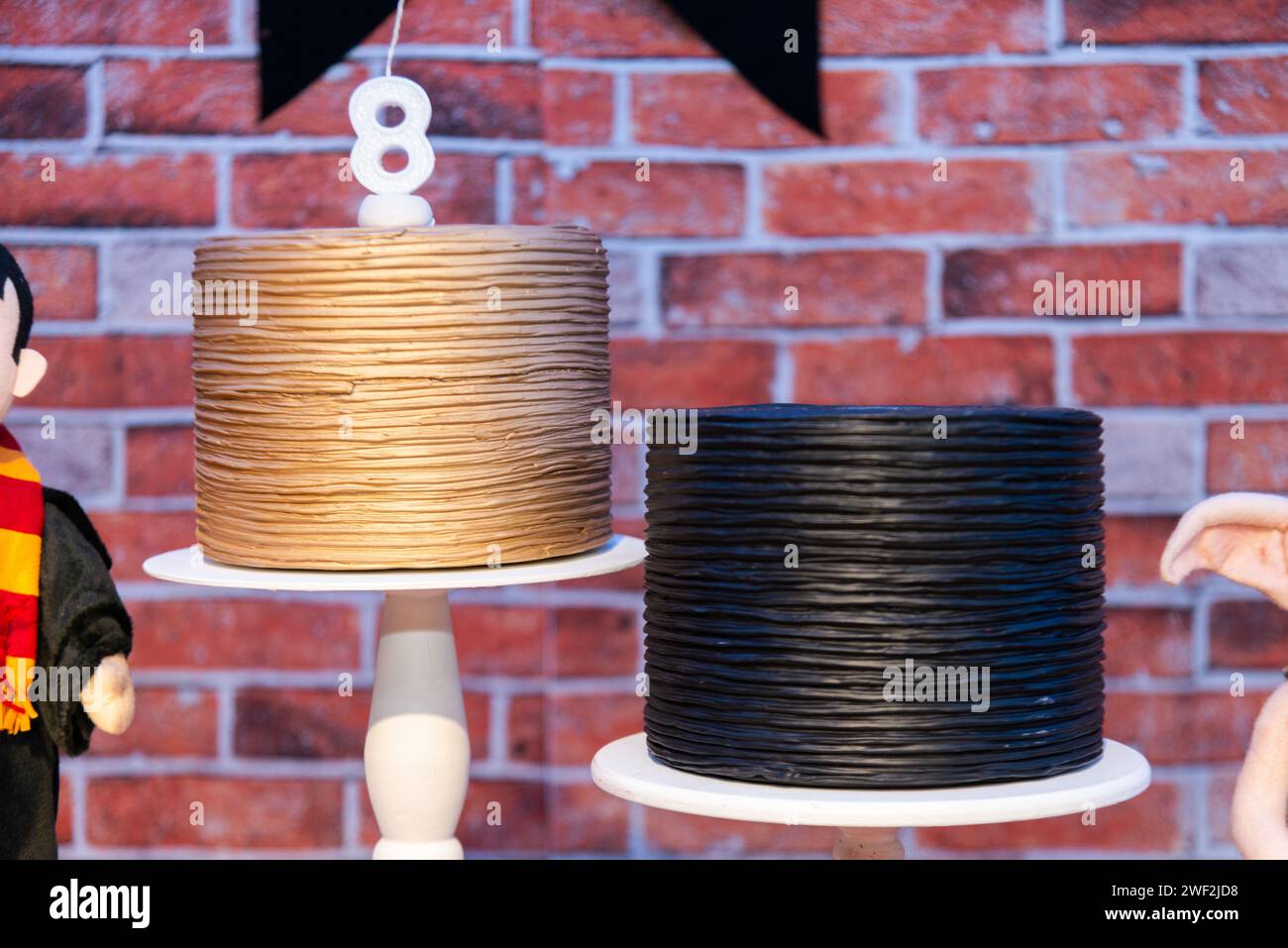 Two Harry Potter-themed cakes with a figurine and a birthday hat Stock ...