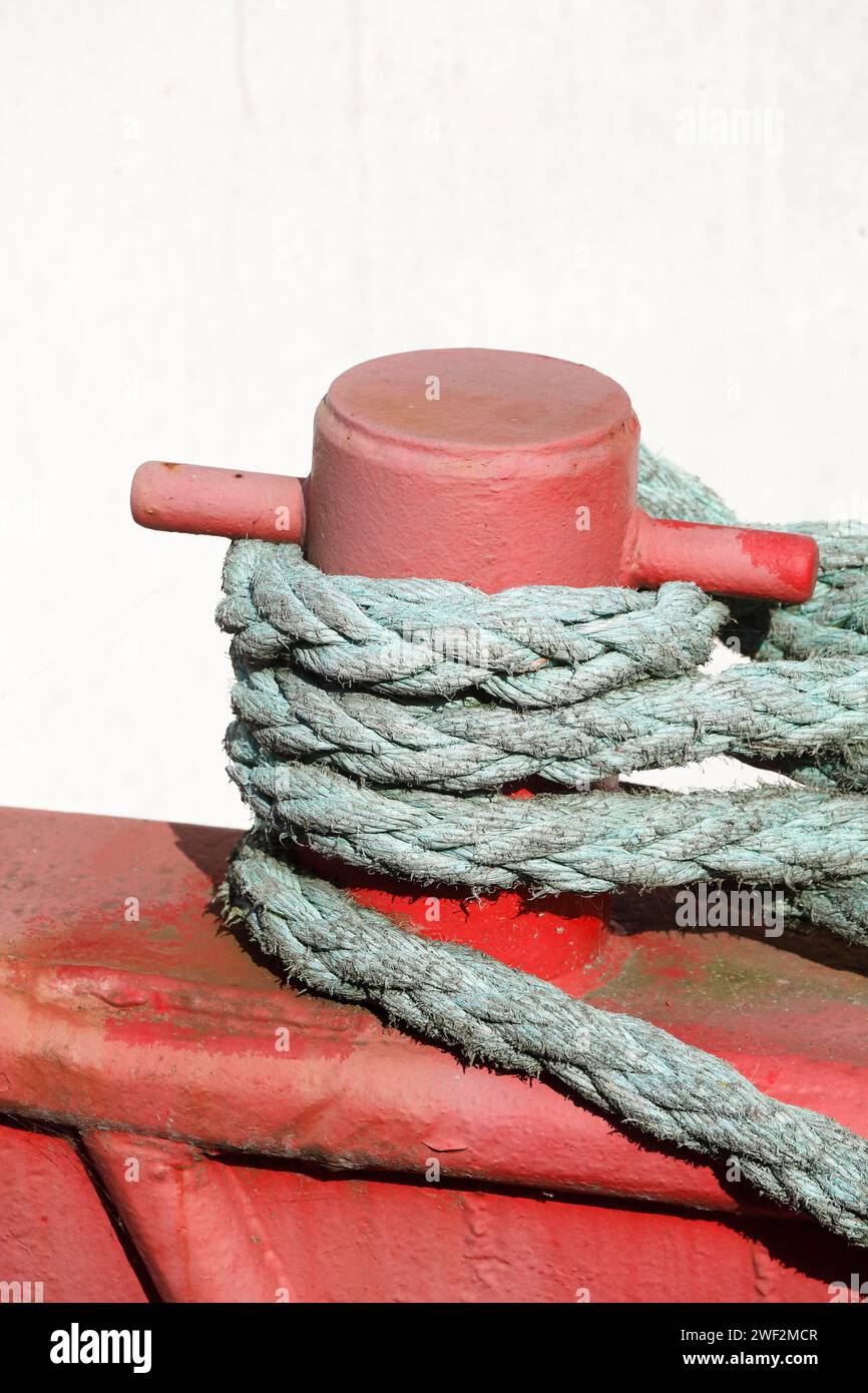 Red ship's bollard wrapped with ship's rope, mooring line, Germany ...