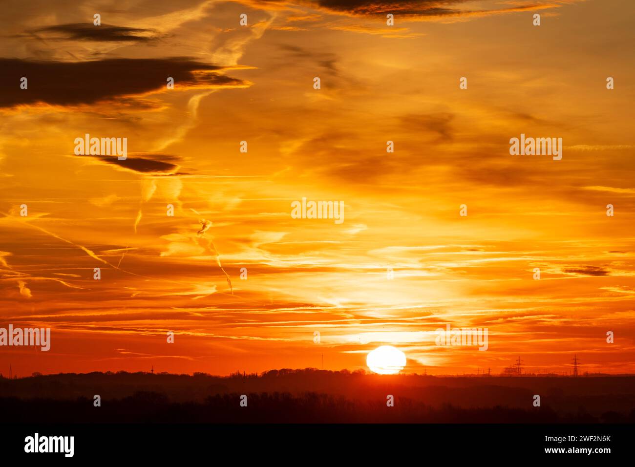 Telephoto shot of the sunrise over the Kent countryside on a winter's ...