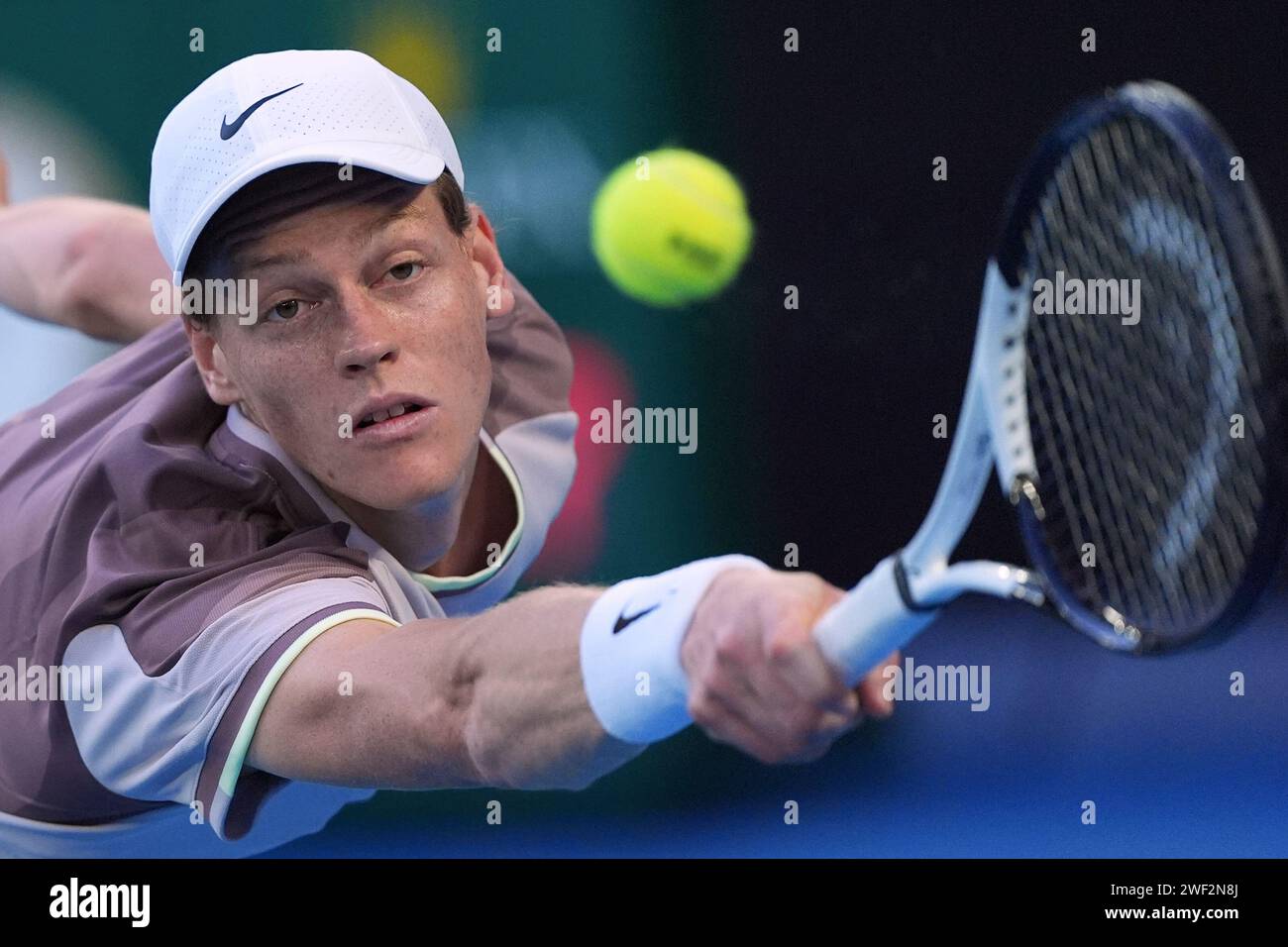 Jannik Sinner of Italy plays a backhand return to Daniil Medvedev of ...