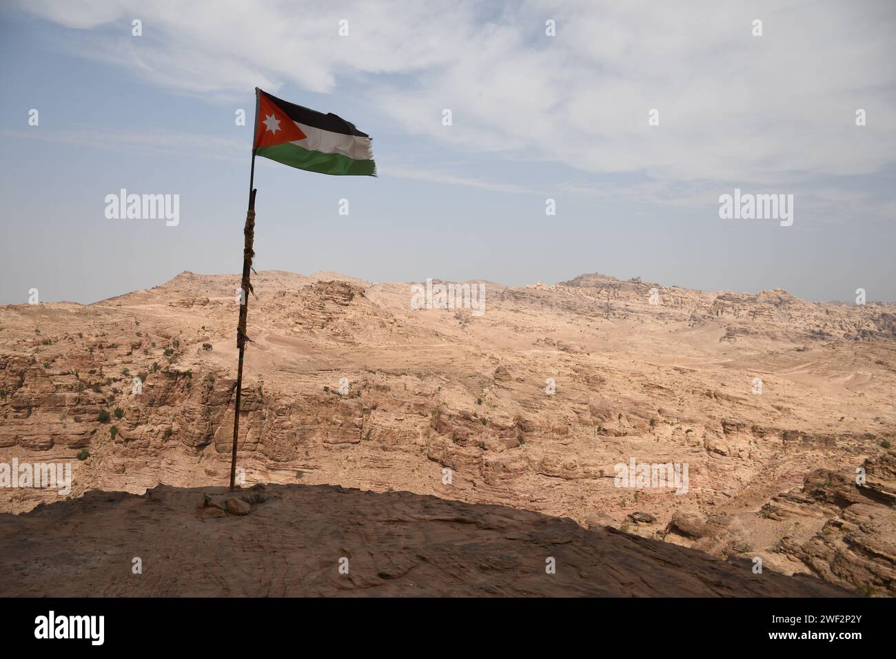 Jordanian flag flies atop a cliff in Jordan Stock Photo - Alamy