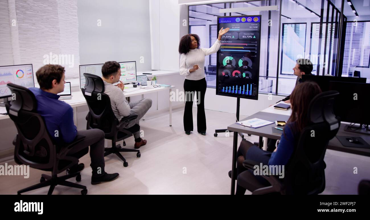 Diverse Team Meeting With TV Screen. Presenter With Dashboard Stock ...