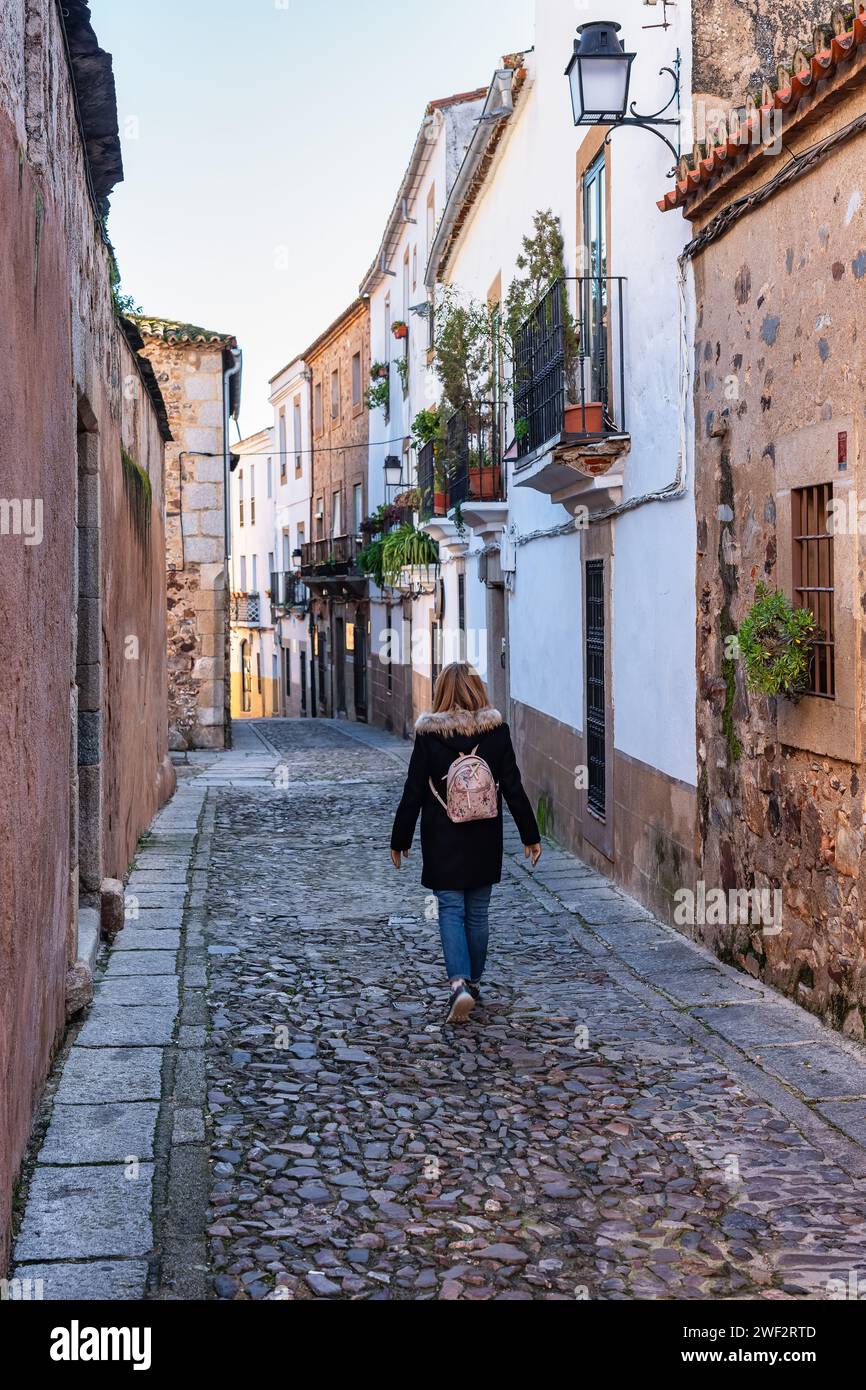 Tourist woman strolling quietly through the narrow streets of the city of Caceres Stock Photo ...