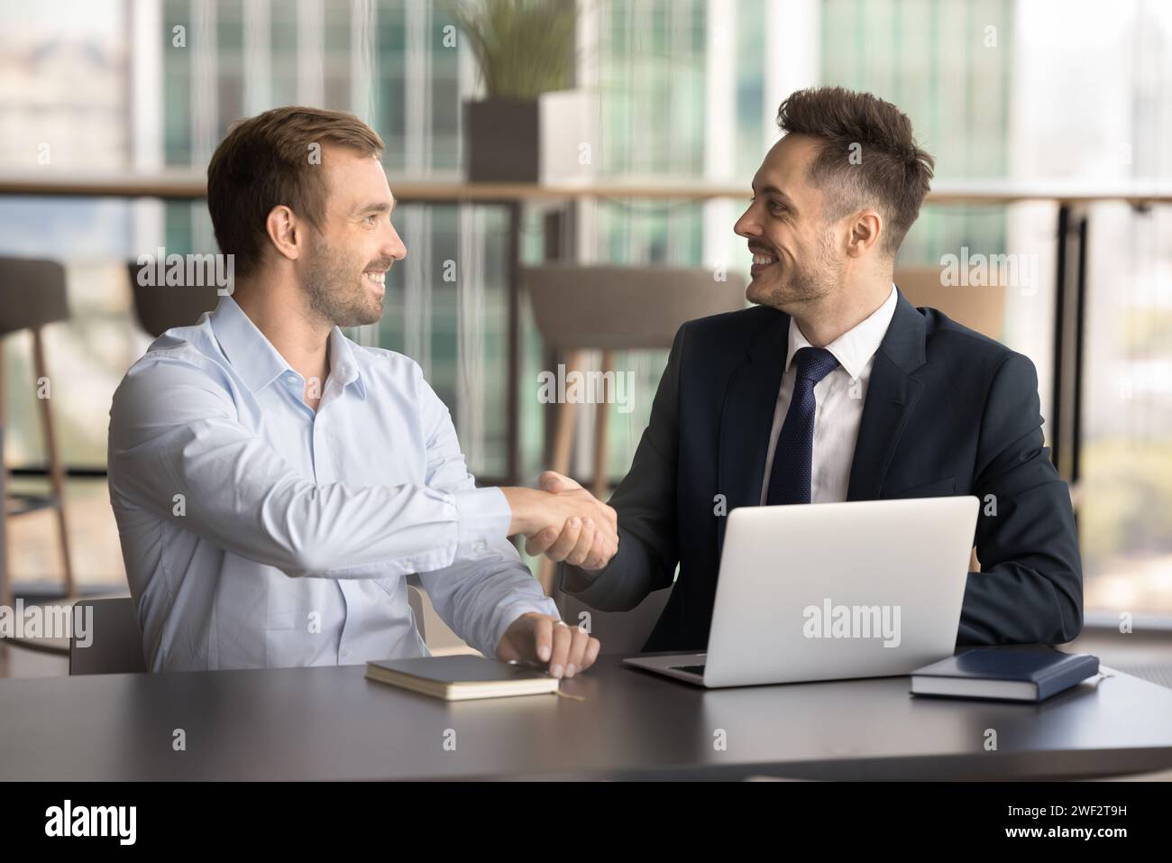 Happy successful business partners men shaking hands Stock Photo - Alamy
