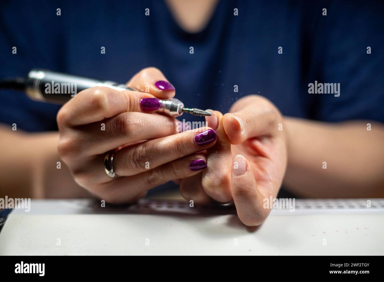 Close up of unrecognisable caucasian female filing her own nails , DIY ...