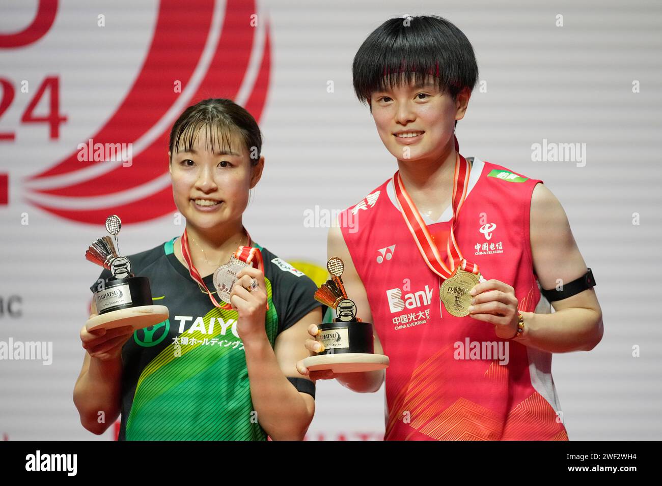 First place winner China's Wang Zhi Yi, right, celebrate with runner-up Japan's Nozomi Okuhara ...