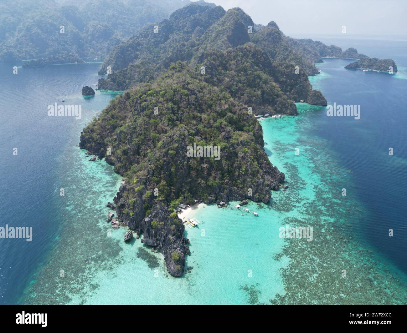 The stunning emerald waters encircle the picturesque island. Coron ...