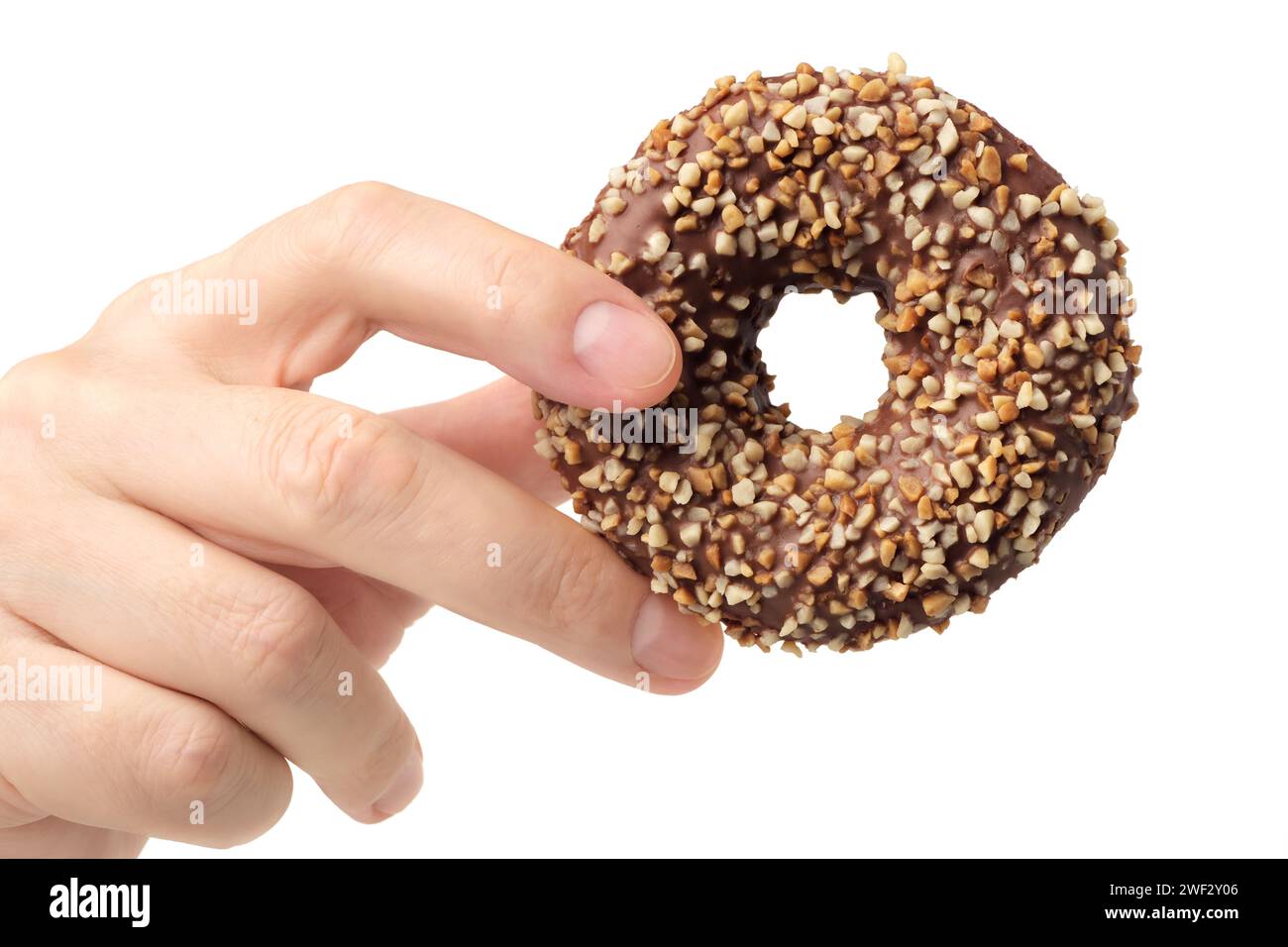 Human hand holding chocolate and crushed nuts donut, front view ...