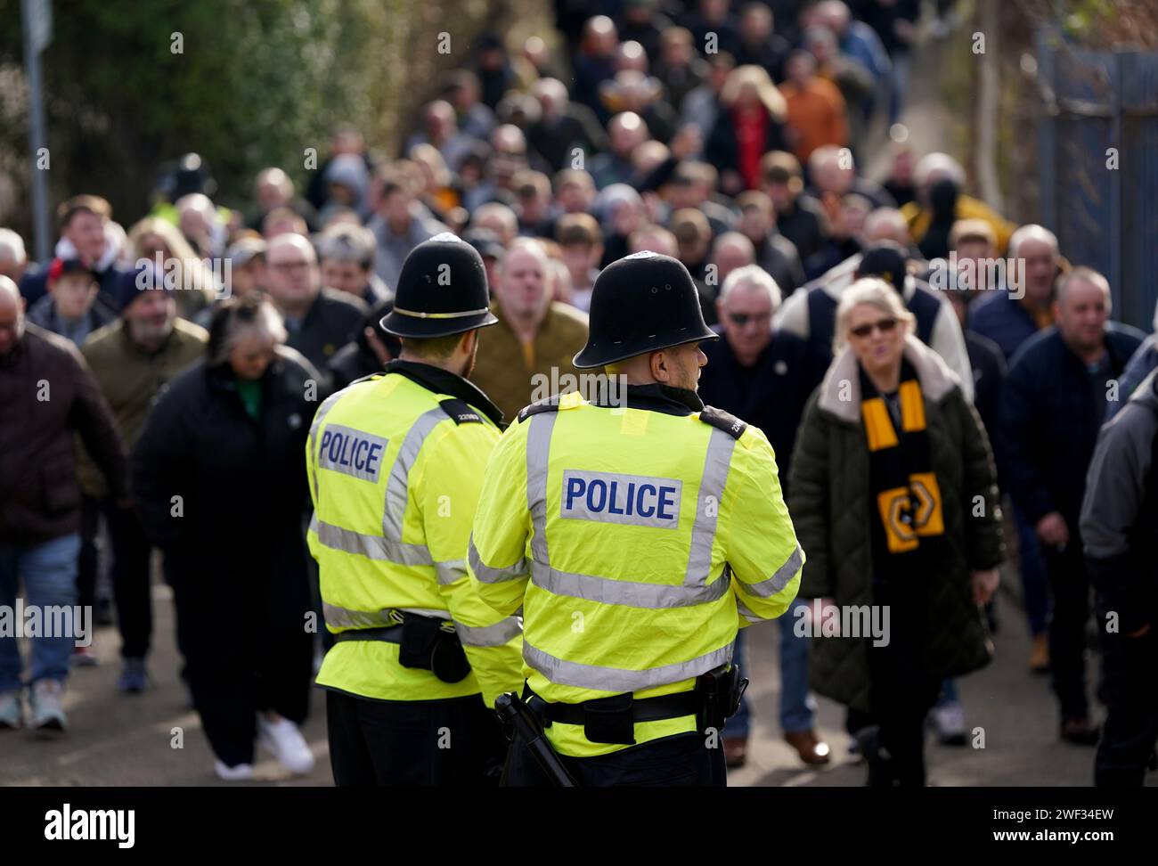 Police officers look on as fans arrive at the ground ahead of the ...