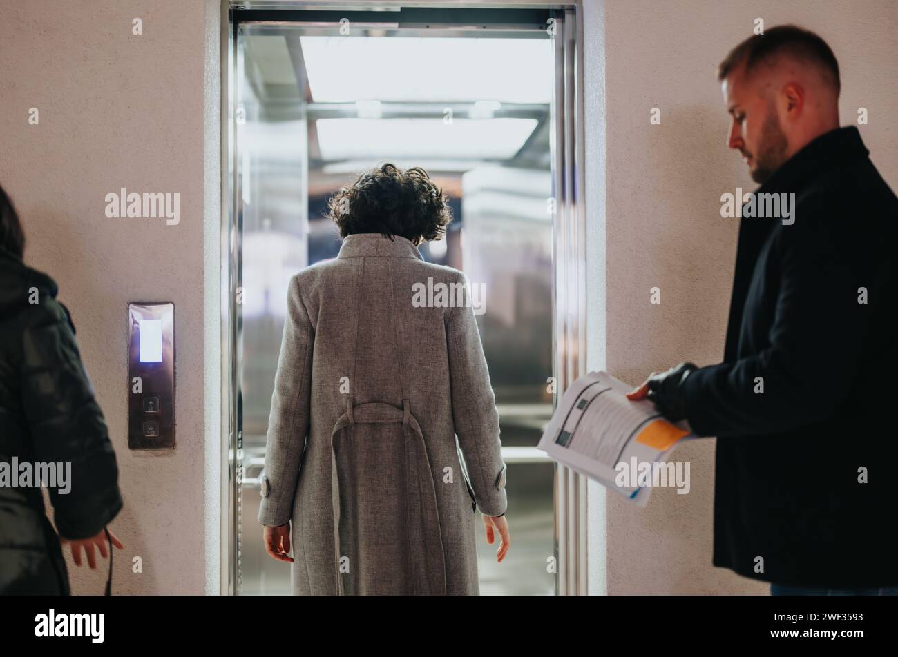 Business professionals entering building using security access code for ...