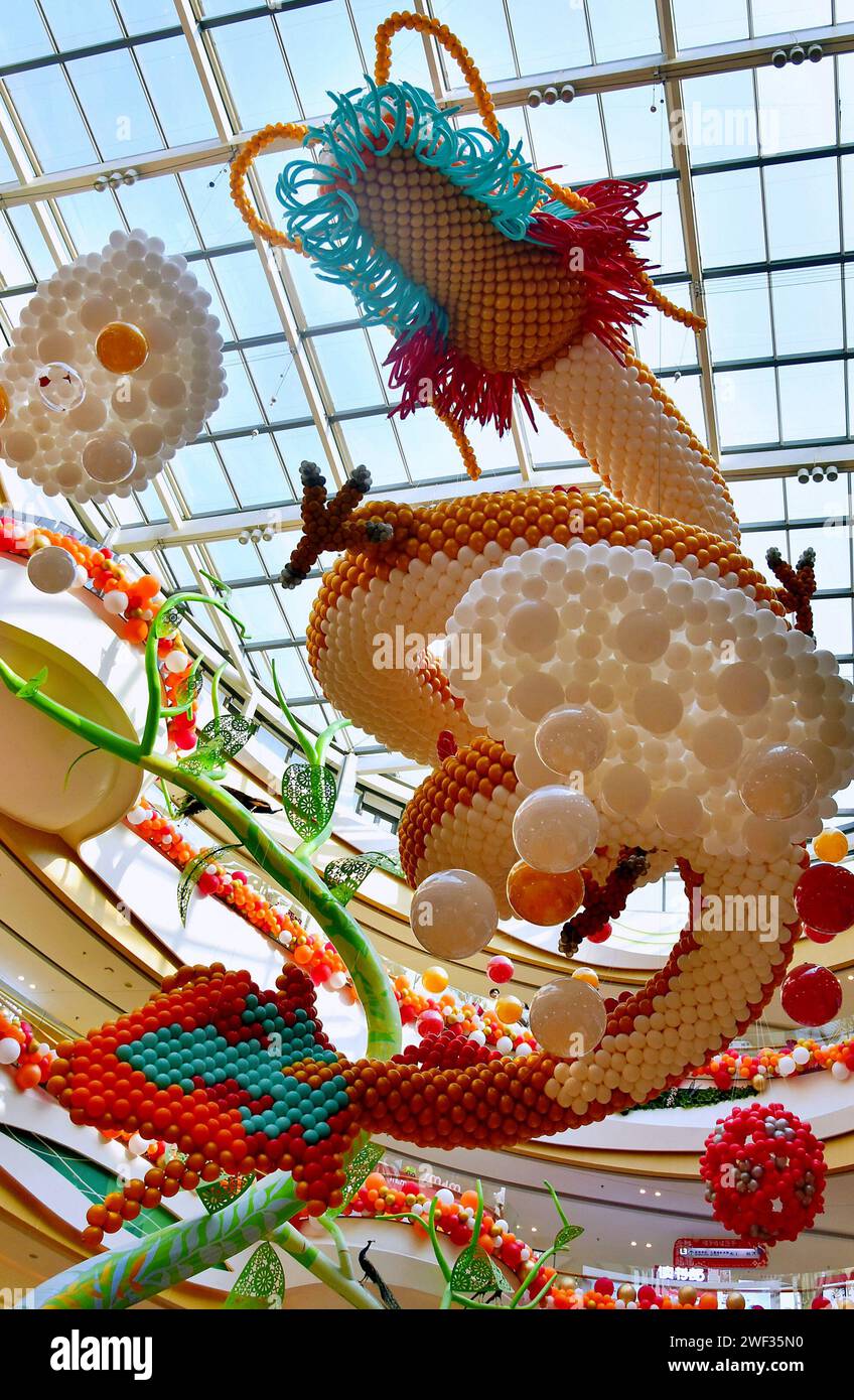 A Chinese dragon made of colorful balloons is hanging in the air at a ...