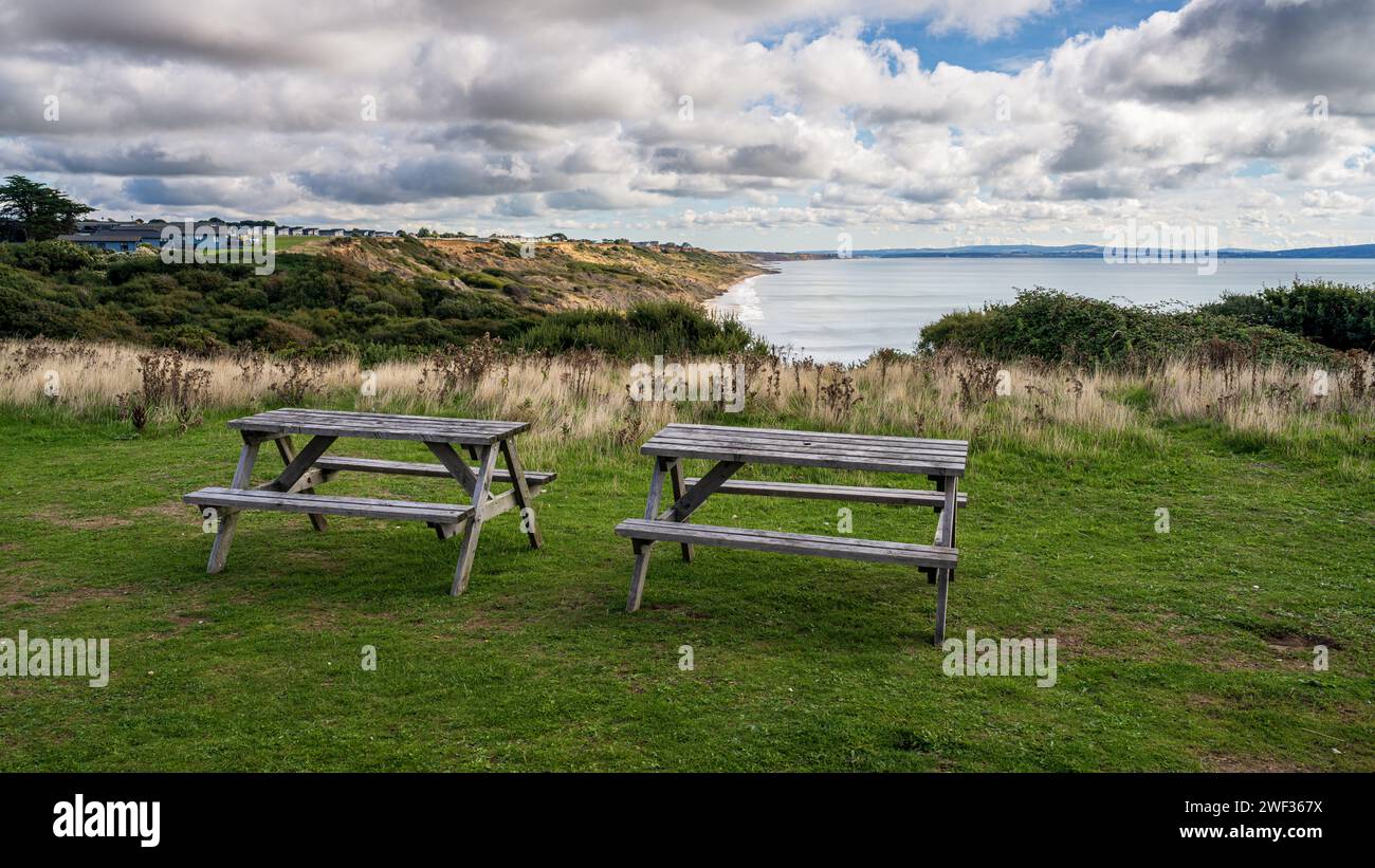 Picnic benches with views of the cliffs and Naish Beach in Highcliffe ...
