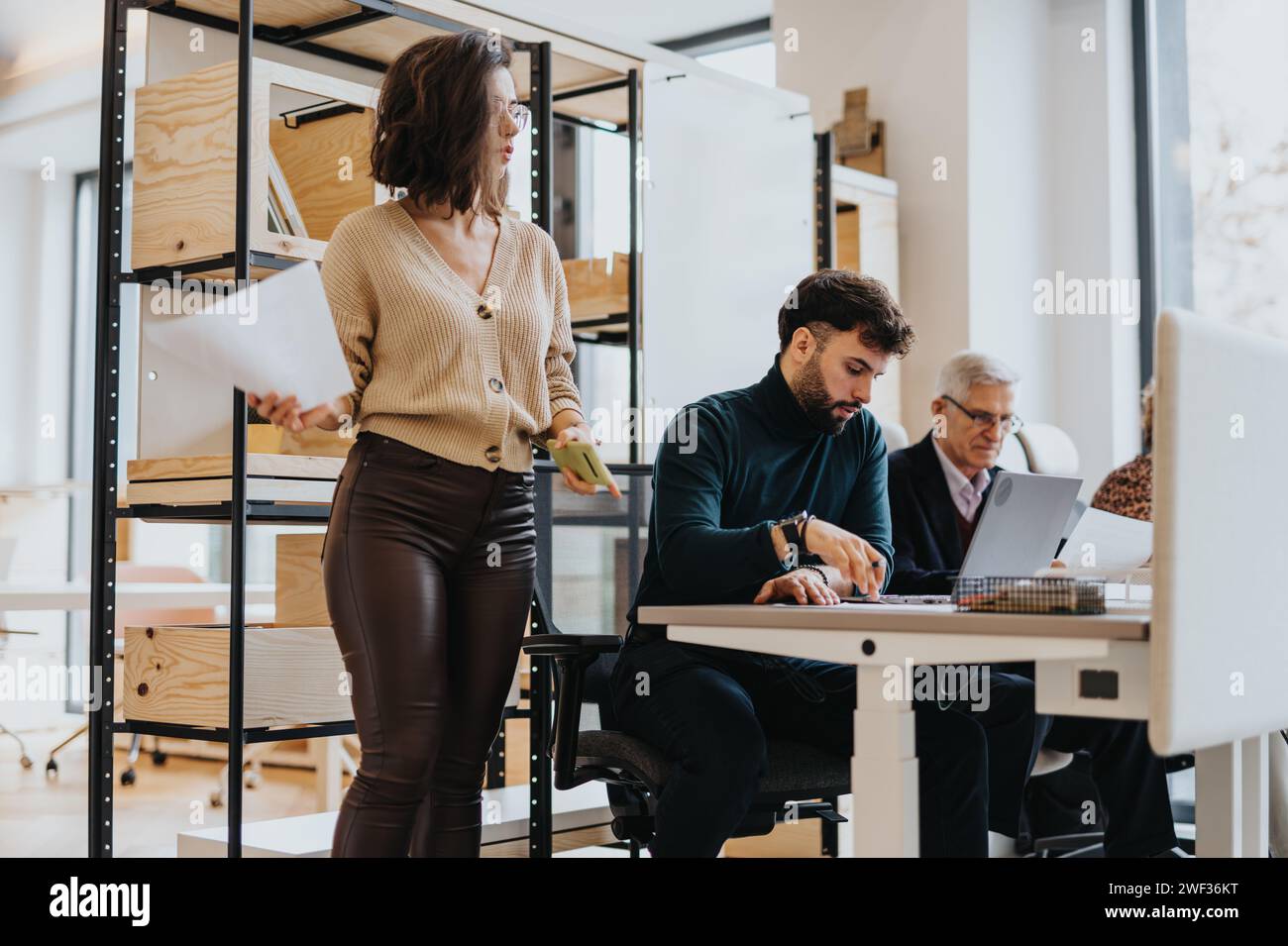 Successful multigenerational team working together in a modern office ...