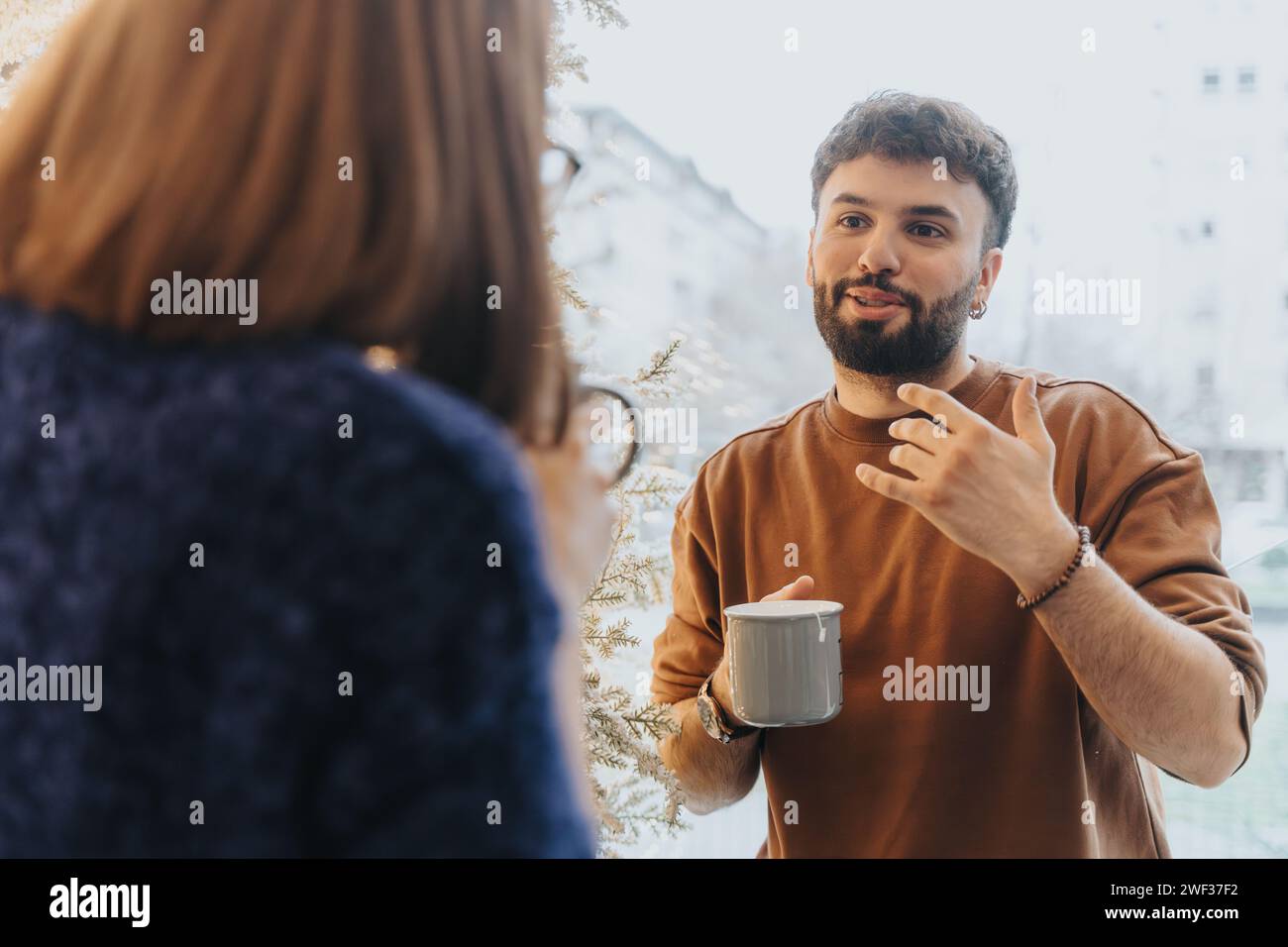 Casual conversation between two friends indoors with natural light ...