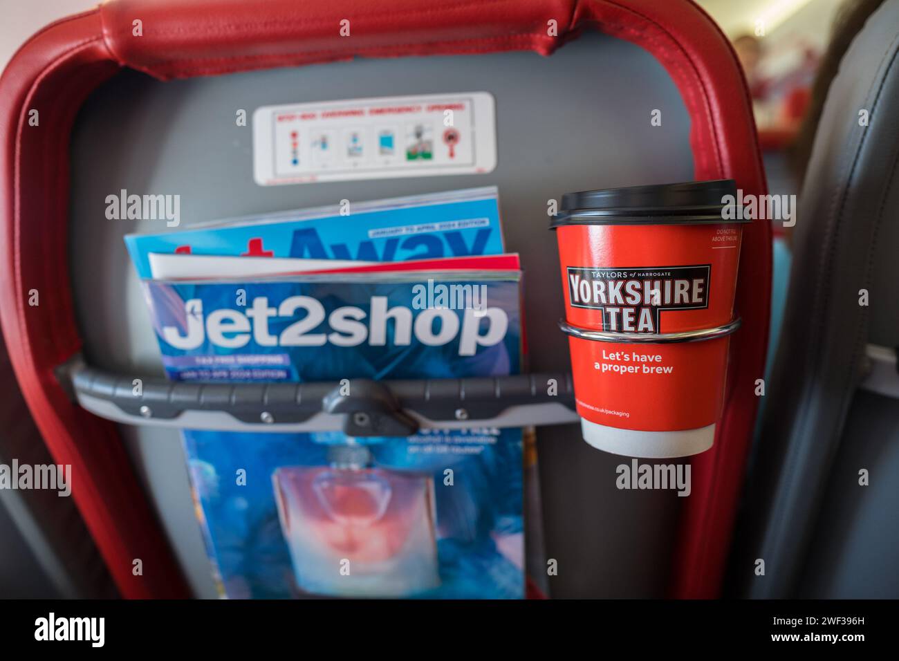 Carboard cup of Yorkshire tea in a metal cup holder on a Jet2 flight ...