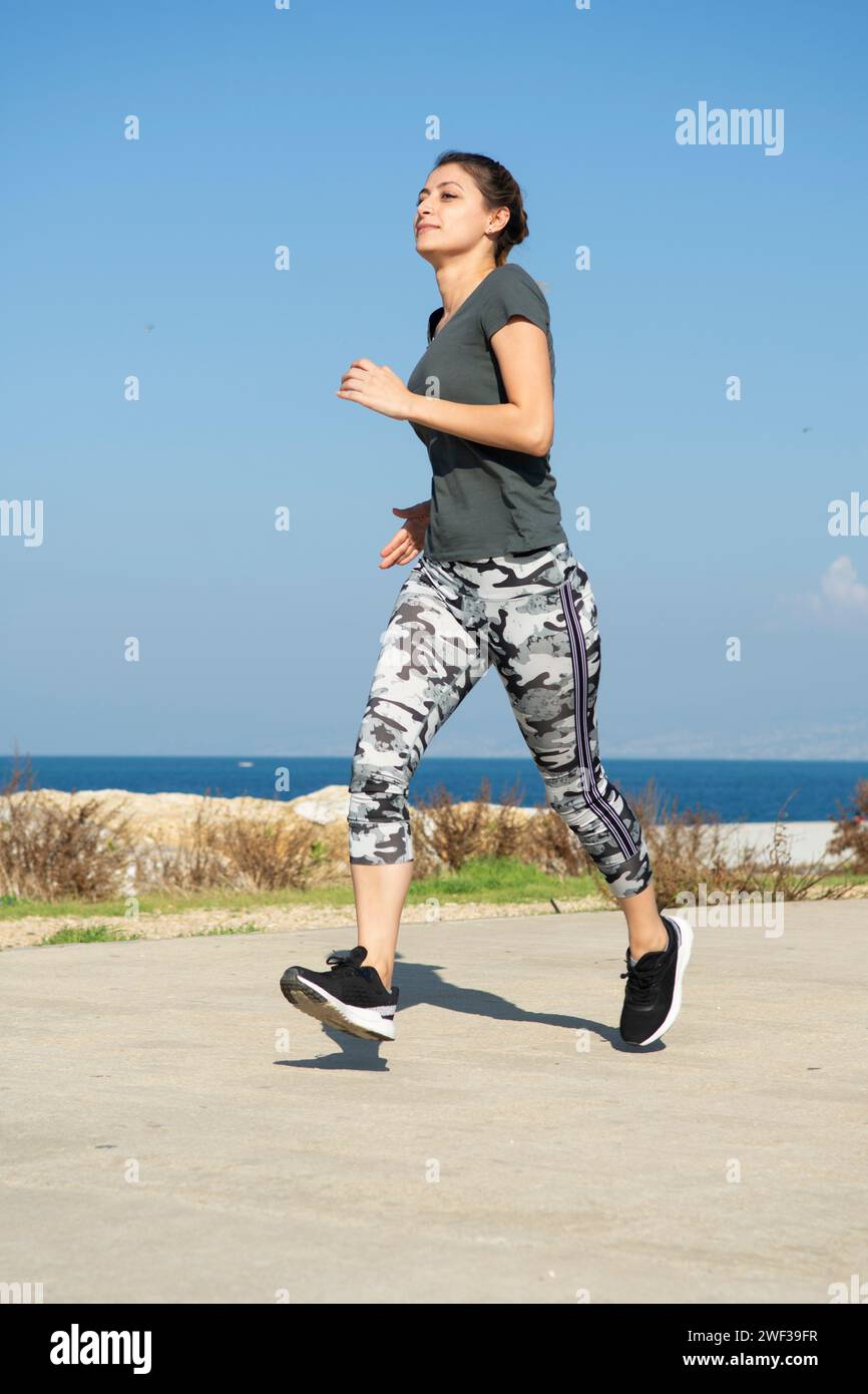 Young woman running out sea hi-res stock photography and images - Alamy