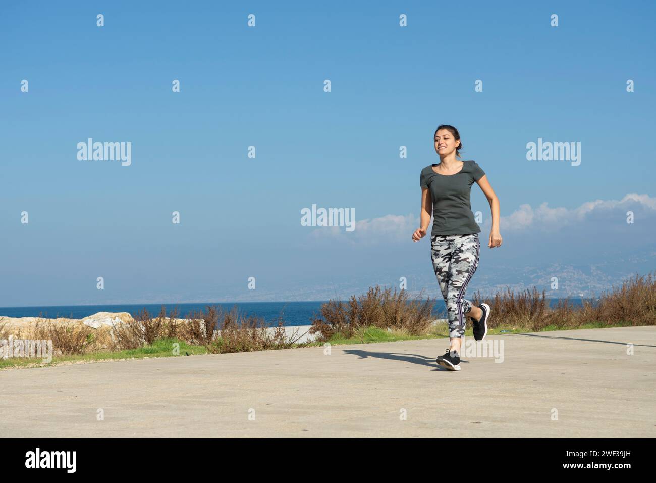 Young woman running out sea hi-res stock photography and images - Alamy