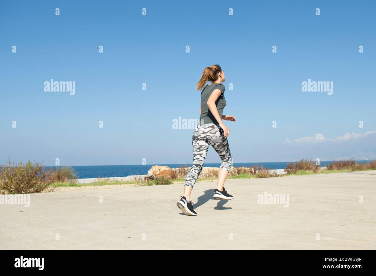 Female running into sea rear view hi-res stock photography and images ...