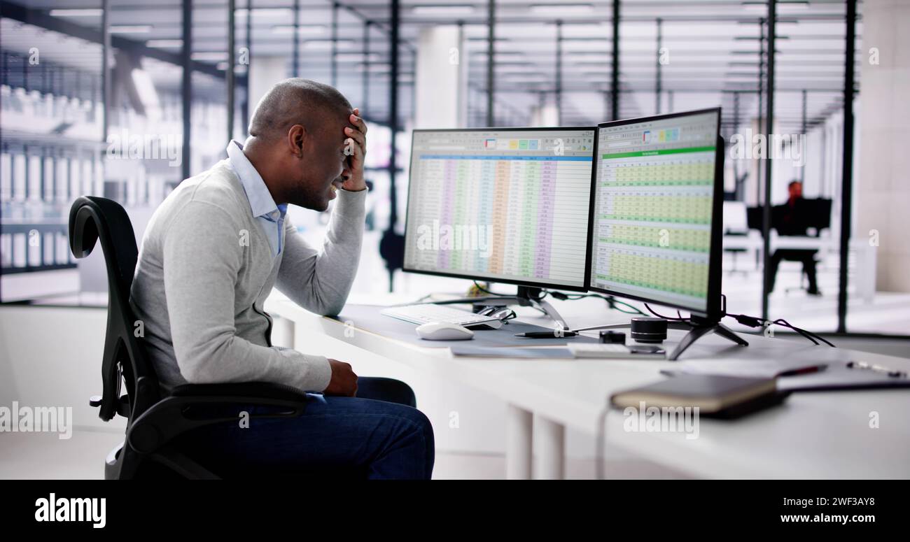 Data Analyst African Man Using Spreadsheet On Computer Stock Photo - Alamy