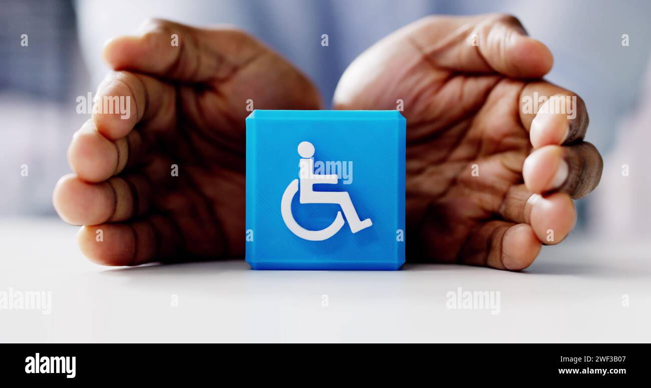 Person's Hand Protecting Blue Cubic Block With Disabled Icon Stock ...